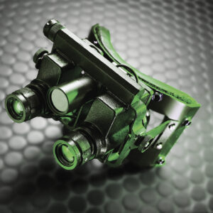 Image of bulky night vision goggles made of black material, but lit with a green light.