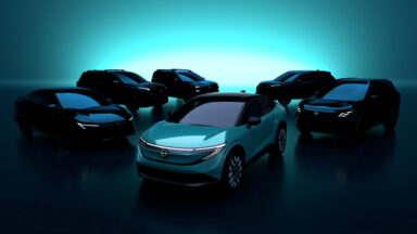 A Nissan Leaf surrounded by other Nissan concepts that are in shadow