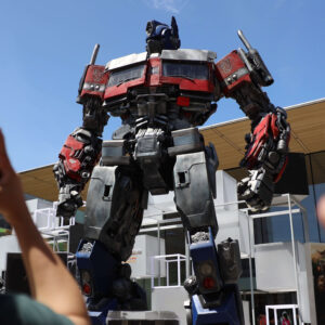 Photograph of a person taking a photograph of Optimus Prime