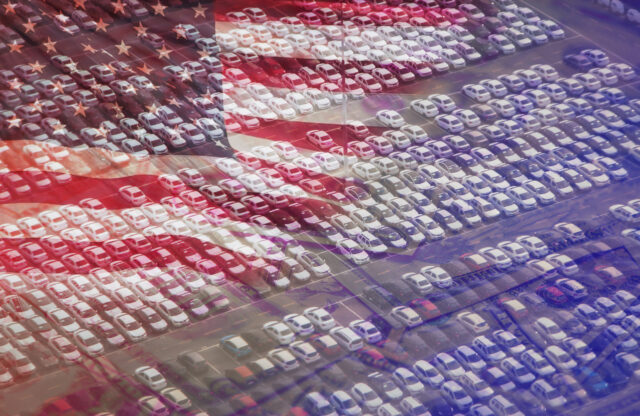Aerial view of car storage or parking lot new unsold EV cars with an American flag superimposed on top