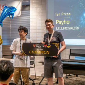 Przemysław Dębiak (right) receives an award for winning the 2025 AtCoder World Finals Heuristic Contest.