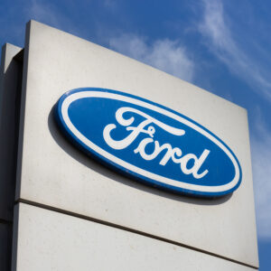 Krasnoyarsk, Russia - May 19, 2022: Close-up Ford brand logo on against blue sky background. Dealership centre of car shop