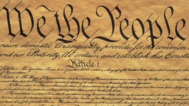 A picture of the opening passage of the US Constitution, beginning "We the people"